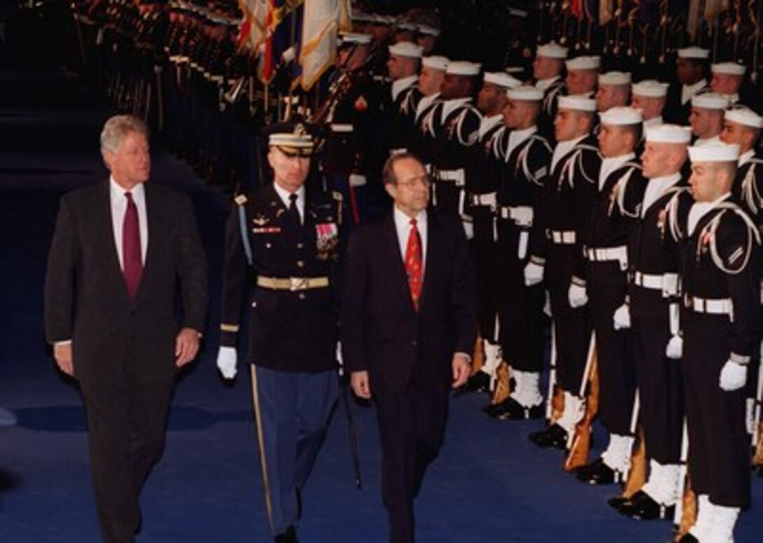President Clinton and Secretary of Defense Perry inspect the troops at ...