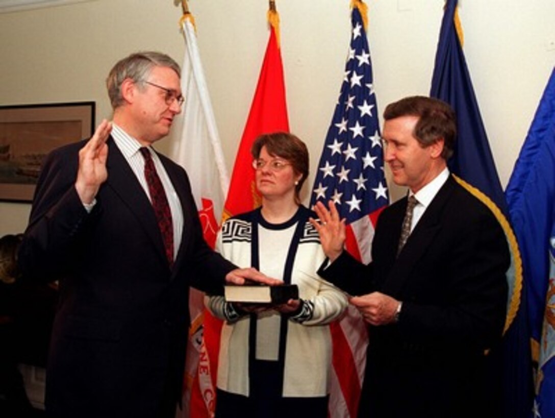 Secretary Cohen administers the oath of office to Dr. John J. Hamre as ...