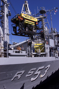 Crew members of the USS Grapple lower the Deep Diving Submersible Drone ...
