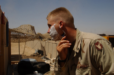 Spc. Brandon Dabb shaves outside at Tarin Kowt, Afghanistan.
