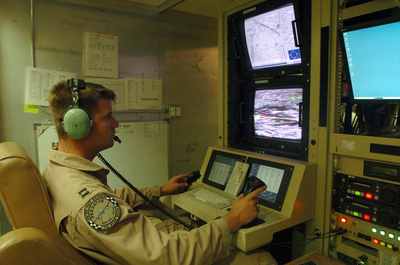 Captain John Songer maneuvers an unmanned Predator reconnaissance ...