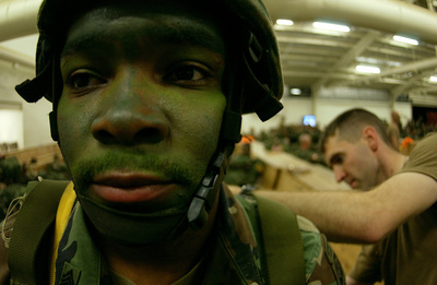 An Army paratrooper and his equipment are prepared for a night ...