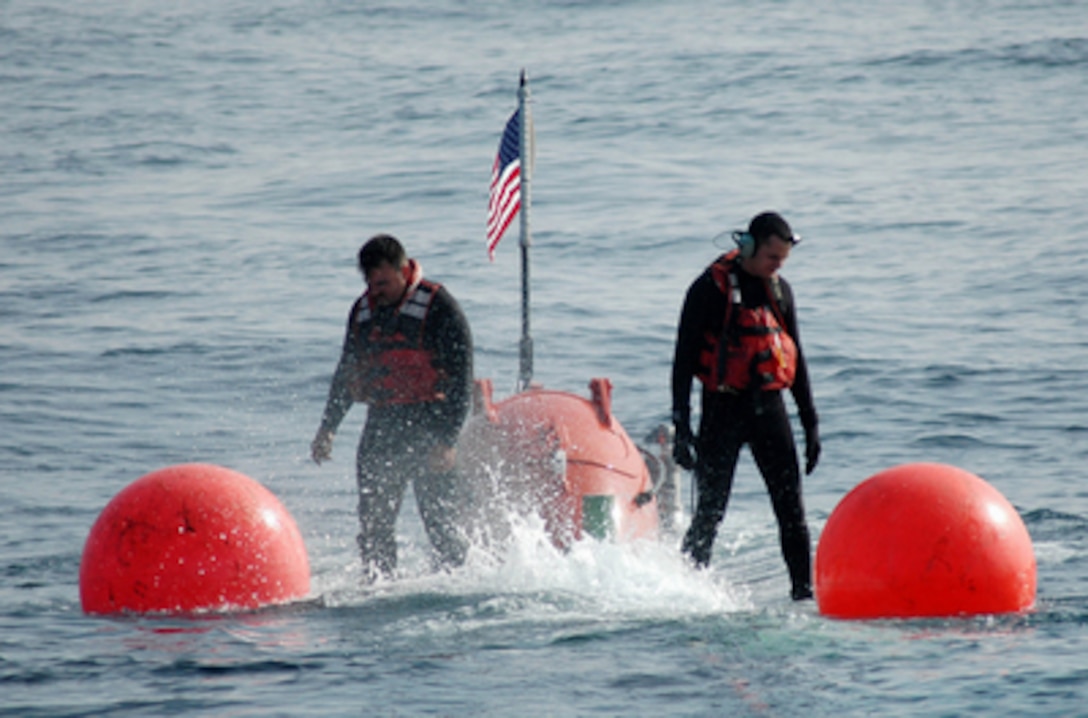 Navy Petty Officers 2nd Class David Tynes and John Garcia conduct ...