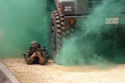 A U.S. Marine uses the cover of a truck and green smoke. | U.S ...