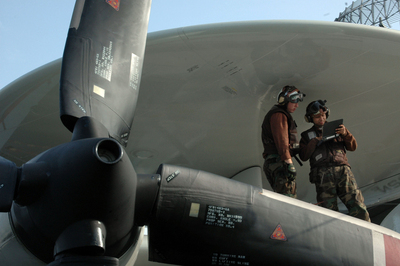 Airman Nathaniel Rich and Airman Ricardo Sawh stand under the shelter ...