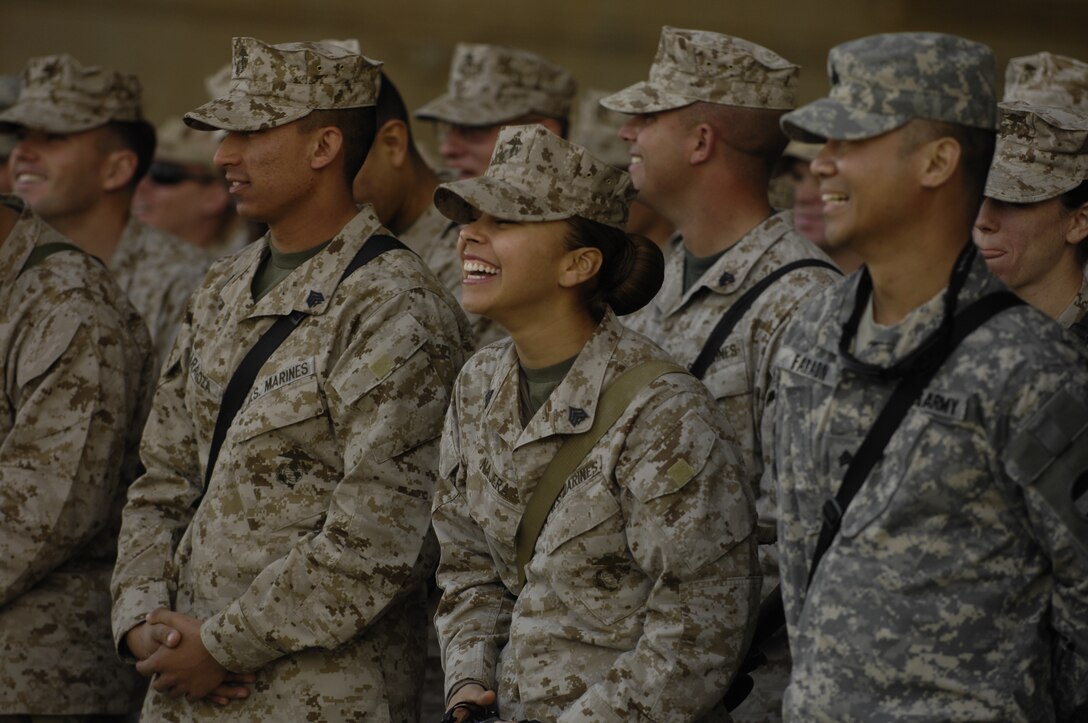 Servicemembers assigned to Al Asad Air Base, Iraq, laugh during a Town ...