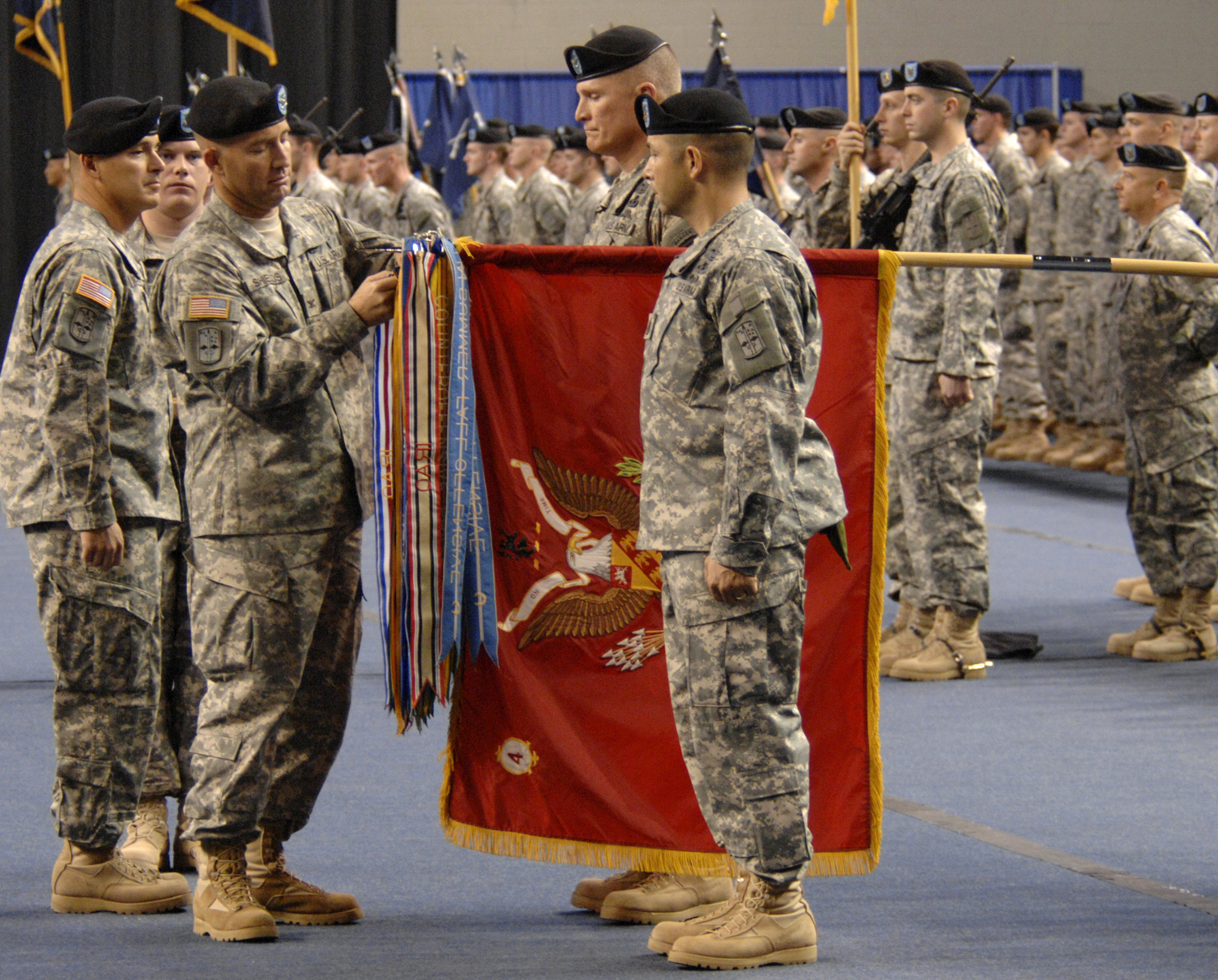 U.S. Army Col. Michael Shields attaches a new battle streamer to the ...
