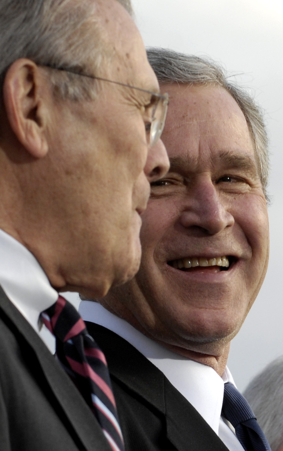President George W. Bush smiles at Defense Secretary Donald H. Rumsfeld ...