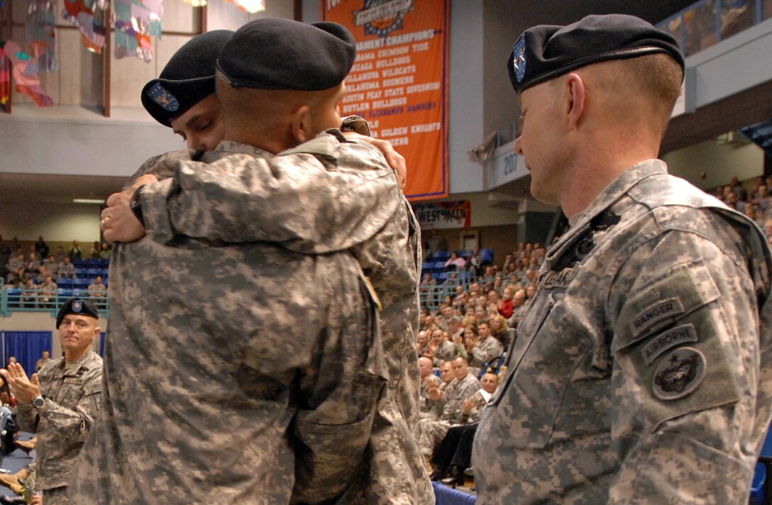 U.S. Army Col. Burdett K. Thompson, center, congratulates U.S. Army Col ...