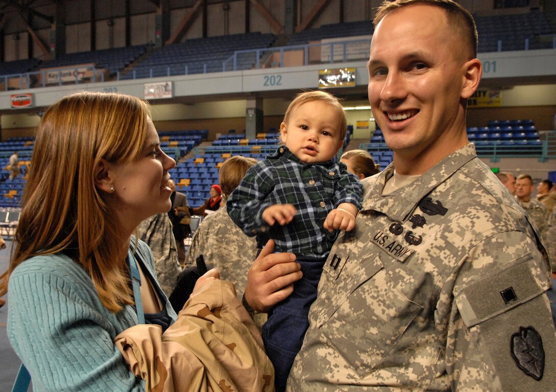 Ashley McCulloh and her husband U.S. Army Capt. Timothy McCulloh hold ...