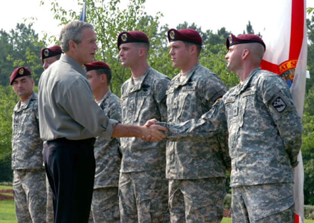 President George W. Bush shakes hands with Sgt. James Stanek ...