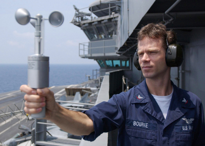 Petty Officer 3rd Class Arthur Bourke measures wind speed and direction.