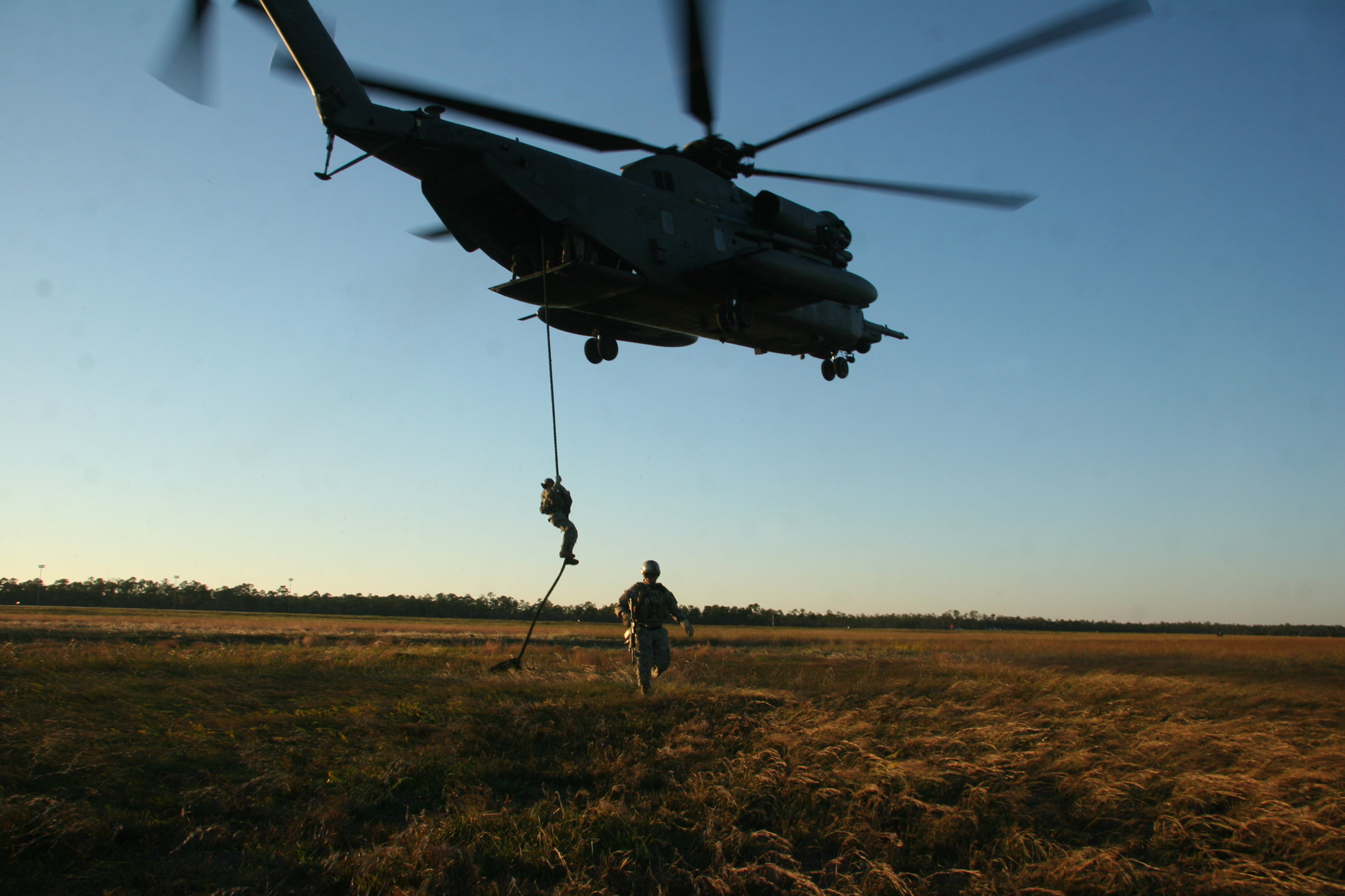 Green Berets practice "fast-roping" from the tail of a MH-53 helicopter