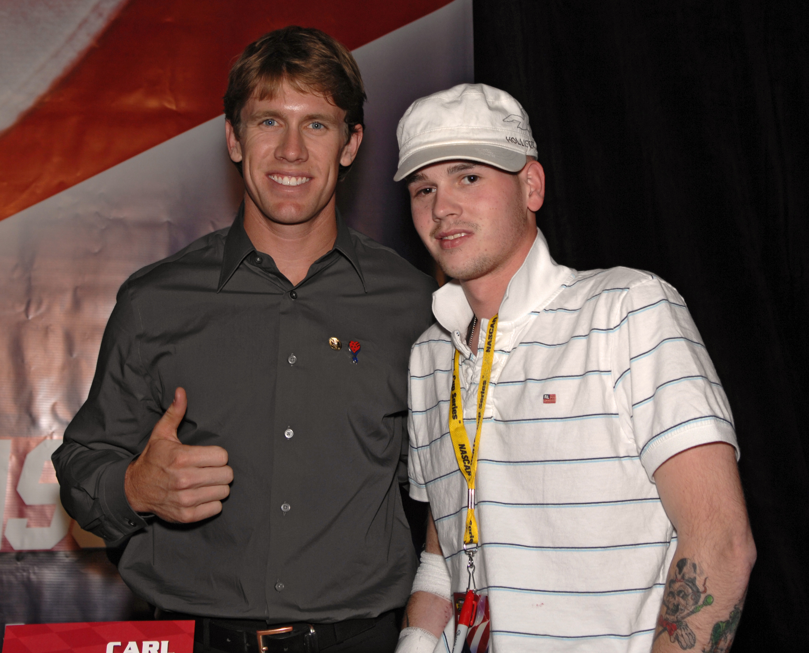 U.S. Army Cpl Christopher Strickland (right) poses for a photo with NASCAR driver Carl Edwards ...