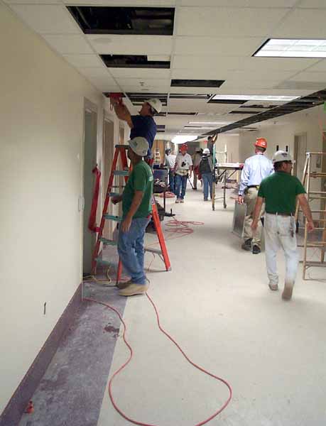 Workers ready communications, electric and air conditioning lines at ...