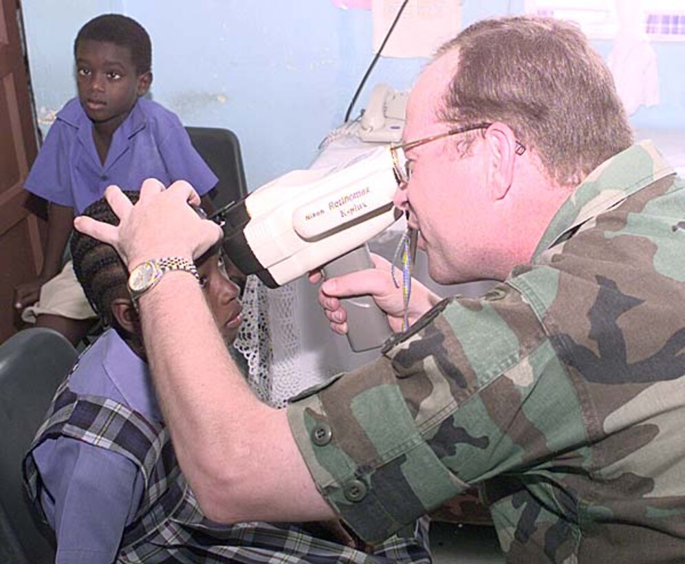 Army Dr. (Col.) William Wilson gives a vision exam to a schoolgirl in ...