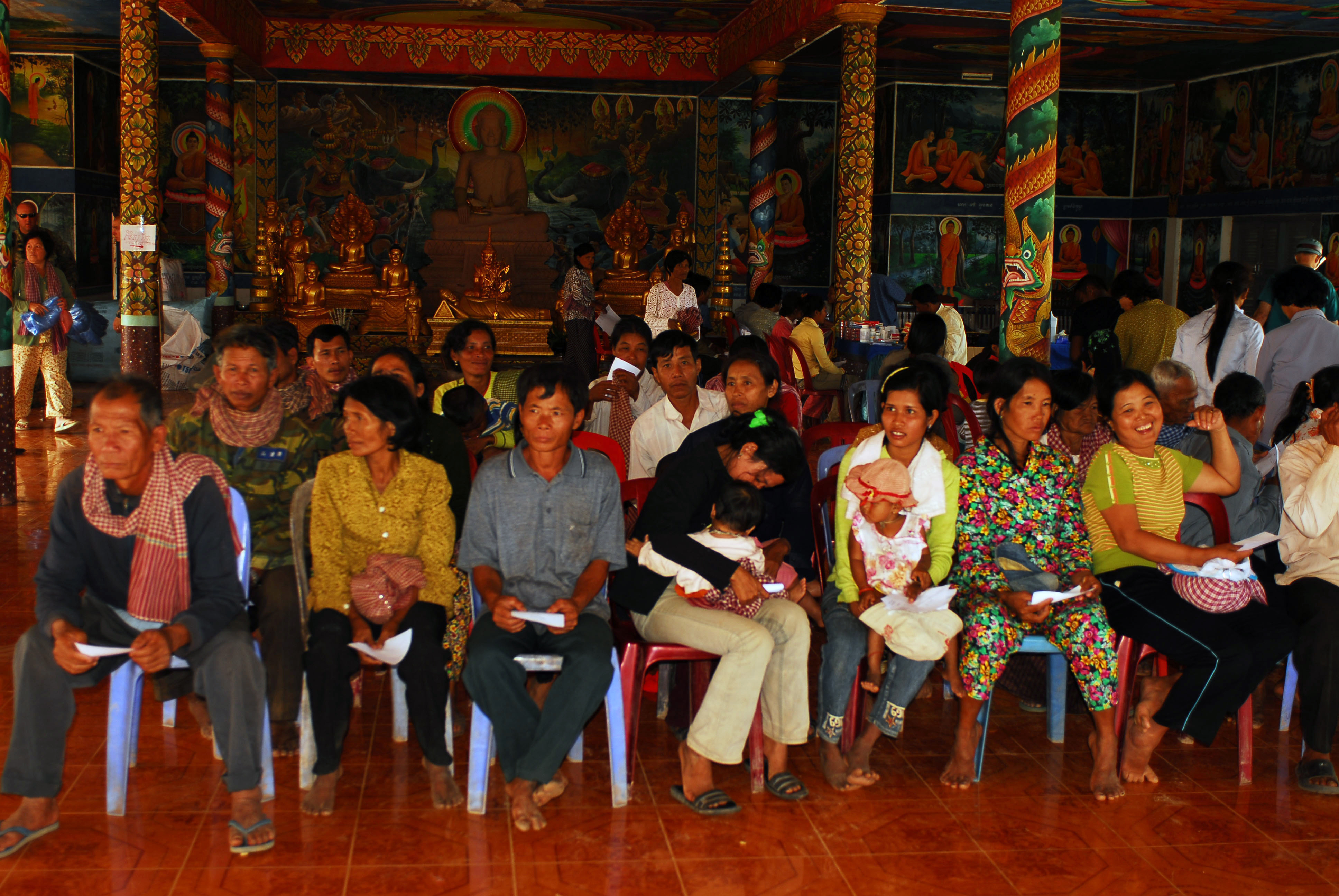 Residents of Kampong Cham, Kingdom of Cambodia, and surrounding area villages wait for a doctor ...