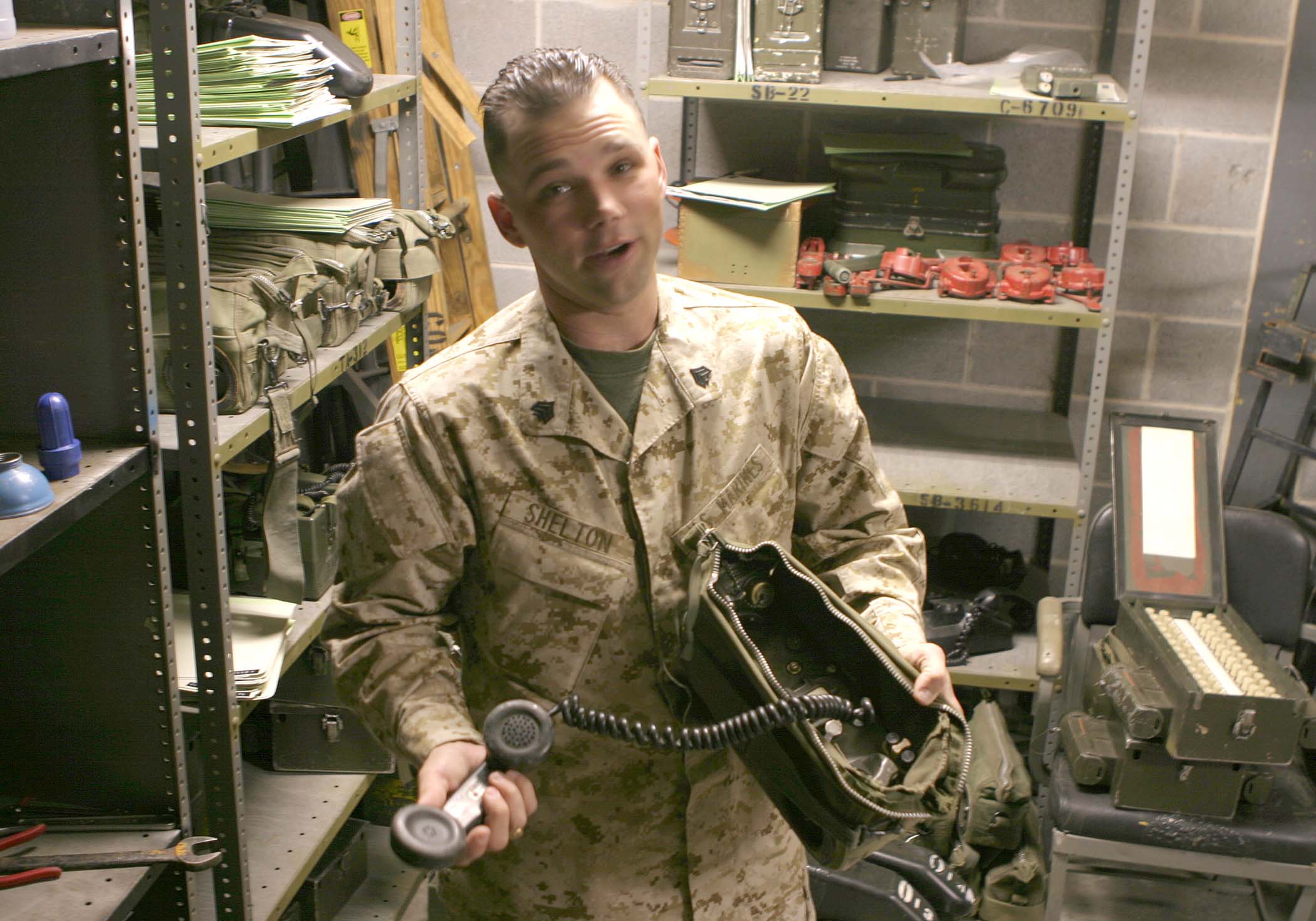 Marine Sgt. Brian F. Shelton spends most of his day inside a wire cage ...