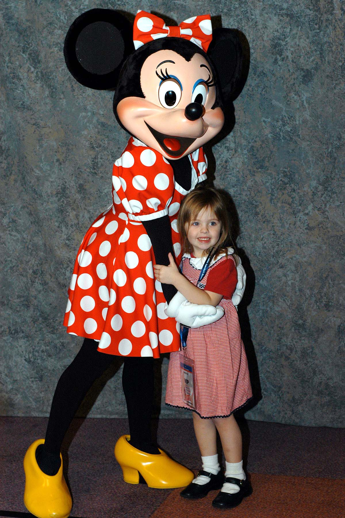 Molly Frei, 3, smiles as she poses for a picture with Minnie Mouse at ...