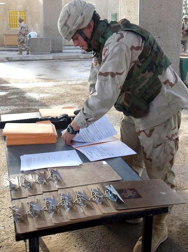 Spc. Justin Cardoza of the 425th Civil Affairs Battalion sets up the ...