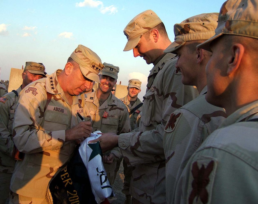 Army Gen. John Abizaid, commander of U.S. Central Command, signs a ...