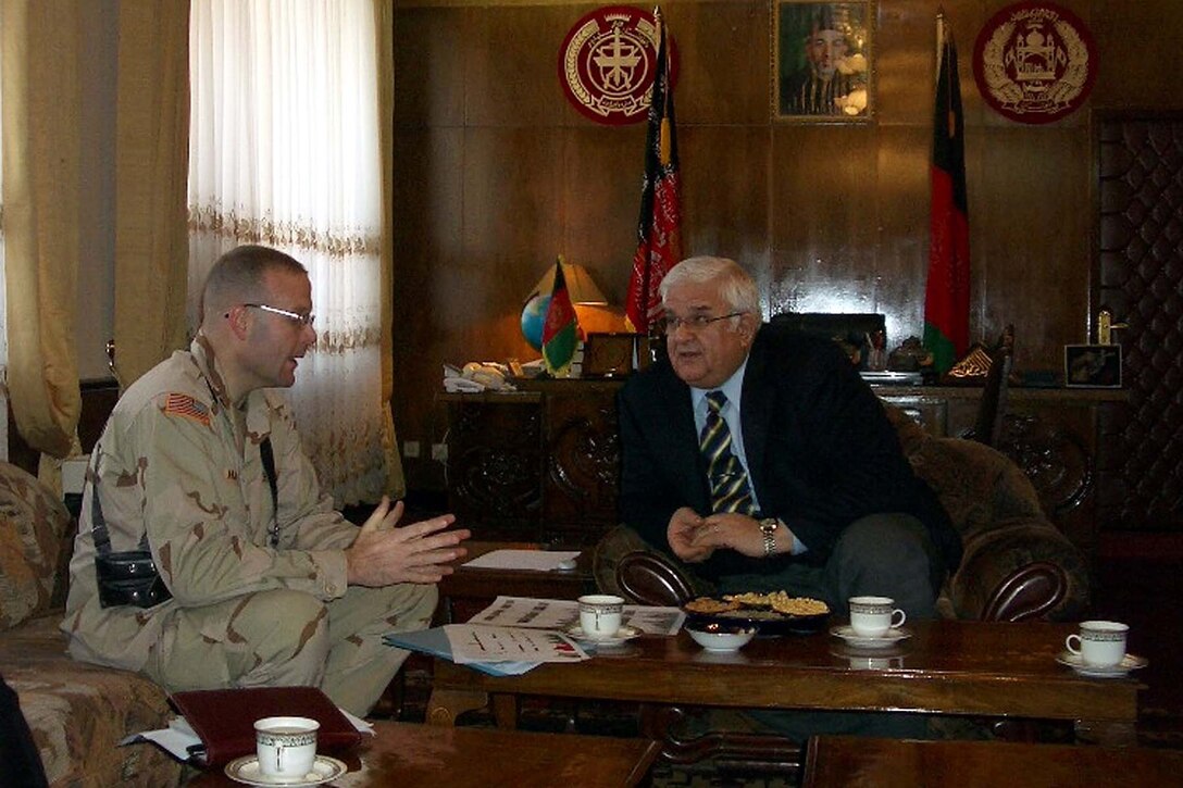 Maj. Doug Hays, left, asks Afghan Defense Minister Abdul Rahim Wardak ...