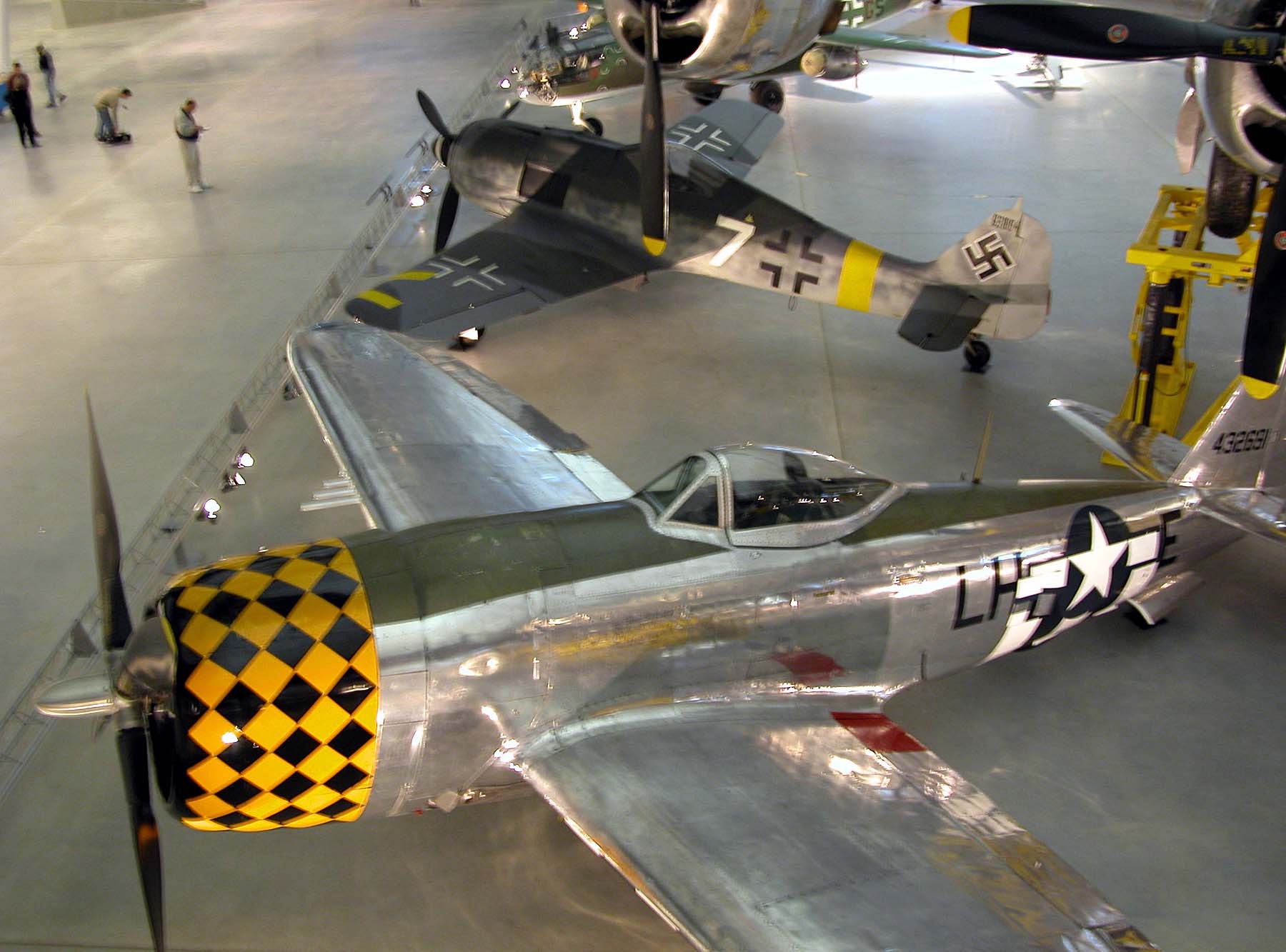 In the foreground, an Army Air Forces P-47. Adjacent is its bitter ...