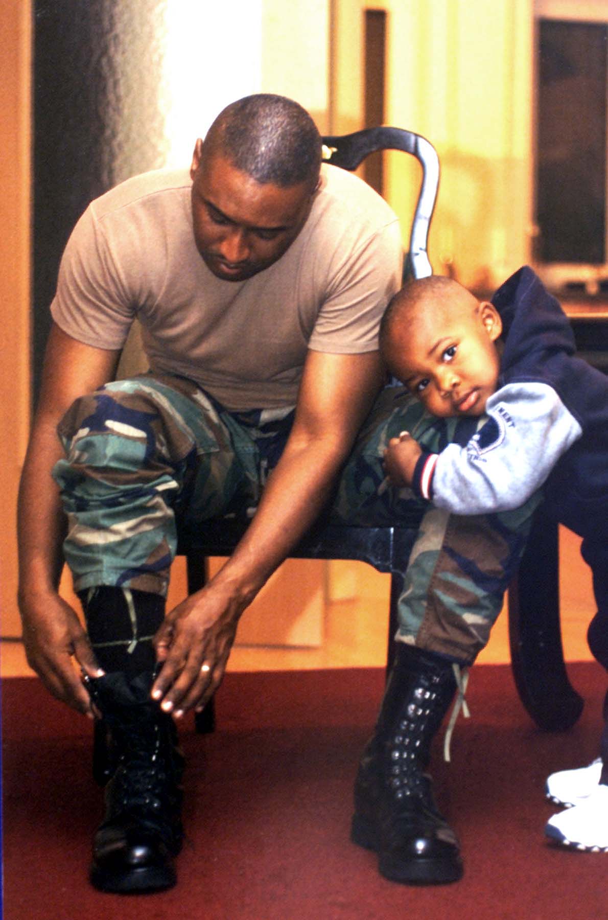 Army Cpl. Eric Wilson photographed 2-year-old Samuel Edwards holding ...