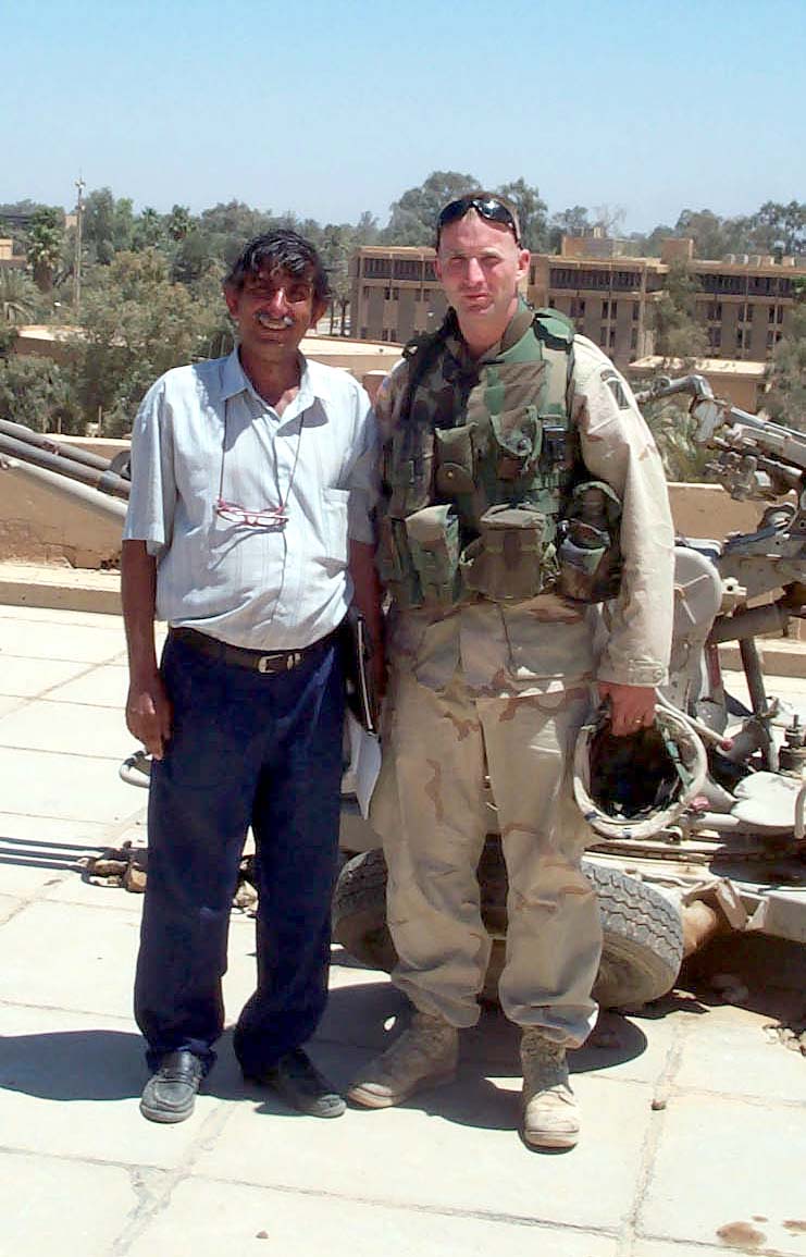 Dr. Jawad Eidam and Army Capt. John Montgomery stand in front of an ...