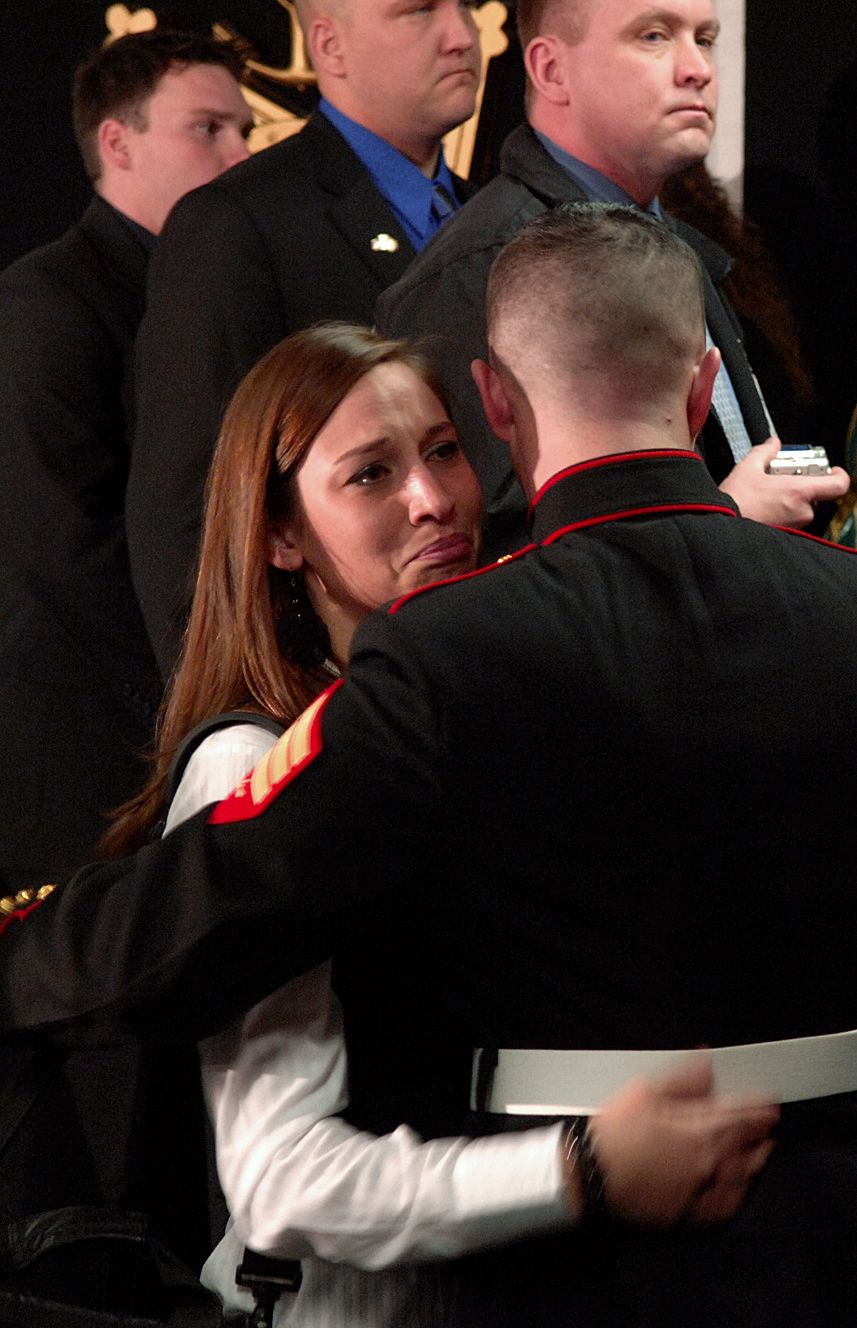 Becky Jo Dean embraces U.S. Marine Corps Sgt. Mark E. Dean at the ceremony posthumously ...