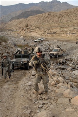 U.S. Army soldiers and Afghanistan National Army soldiers patrol a road ...
