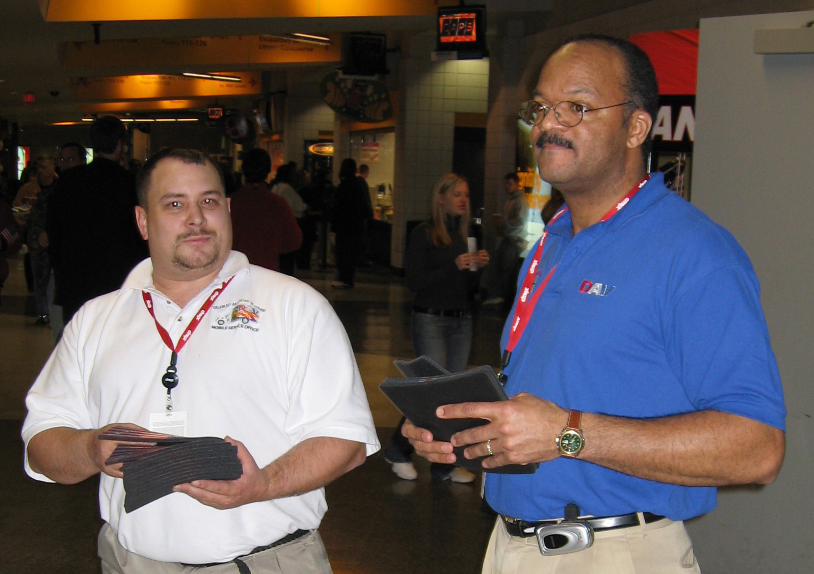 Peter Collins (left) and Gregory Jones pass out complimentary mouse ...