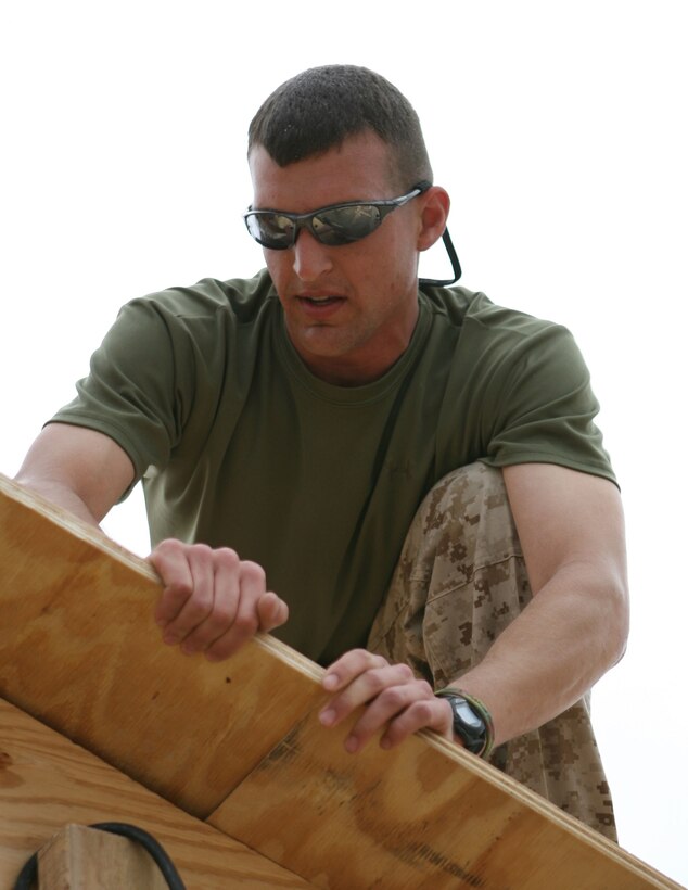 Marine Staff Sgt. Jonathan B. McClary, a combat engineer, wears a ...