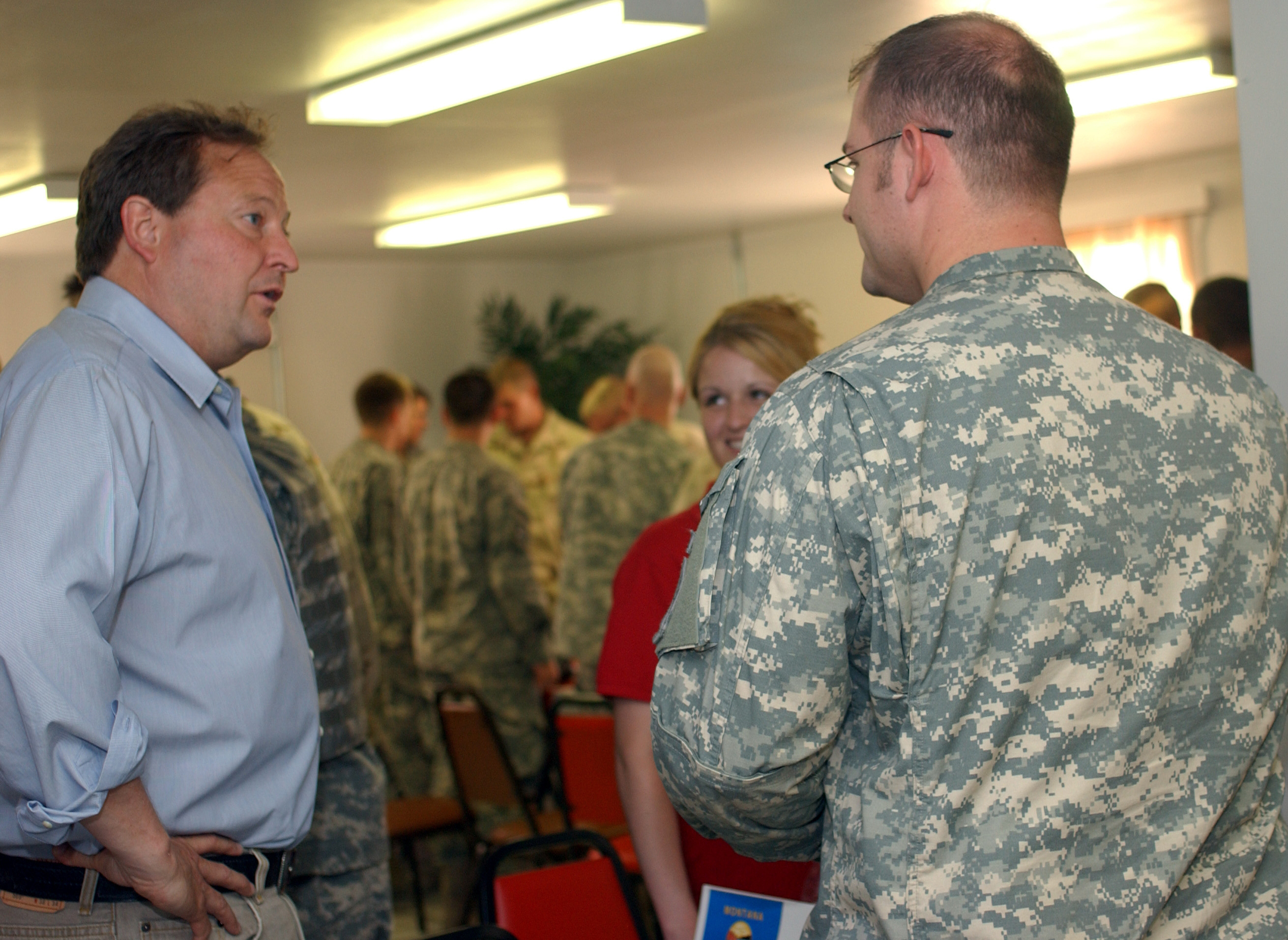 Montana Gov. Brian Schweitzer visits with Army Capt. Chad Ryg, a ...