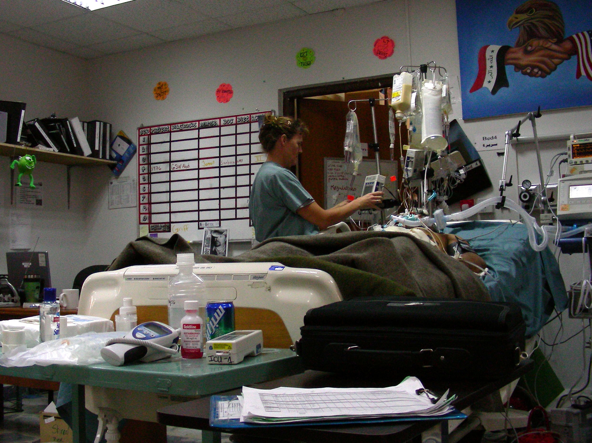 Army Capt. Virginia Griffin monitors instruments used to treat a ...