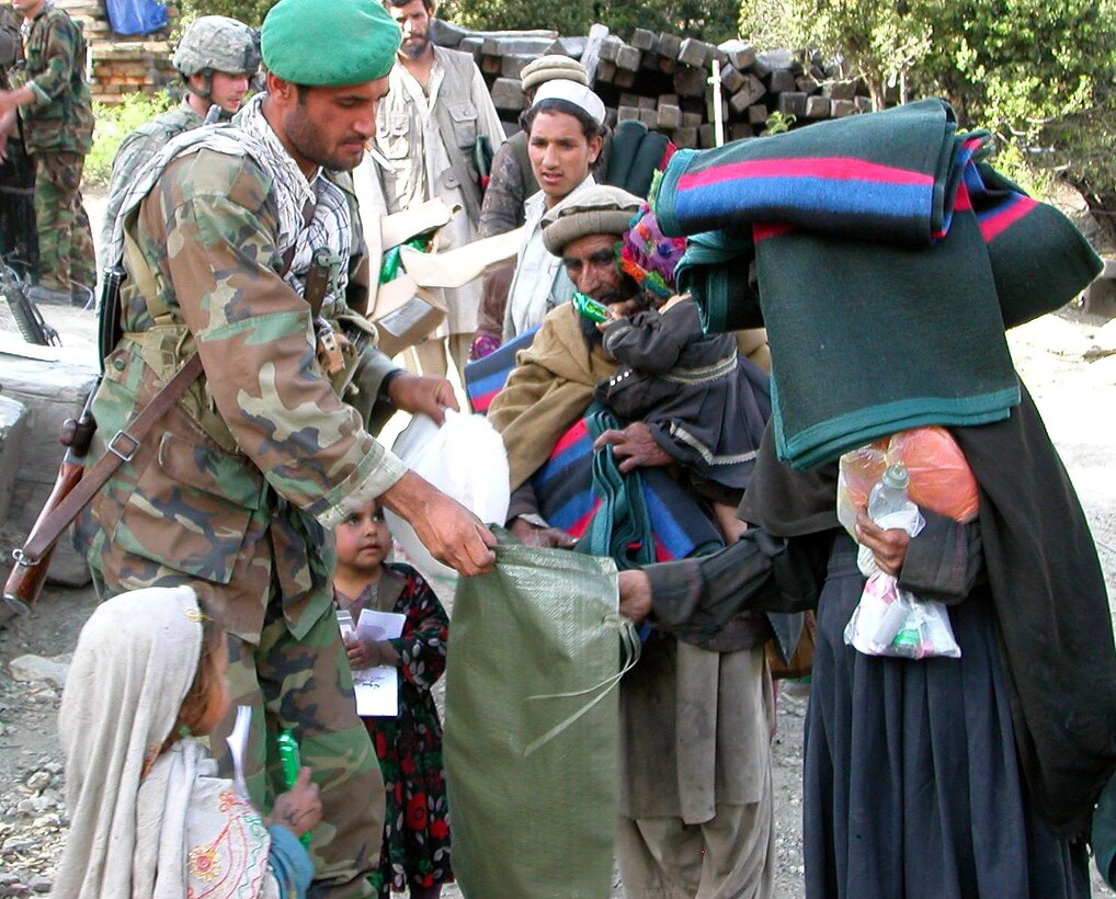 Afghan National Army soldiers hand out humanitarian assistance as part ...