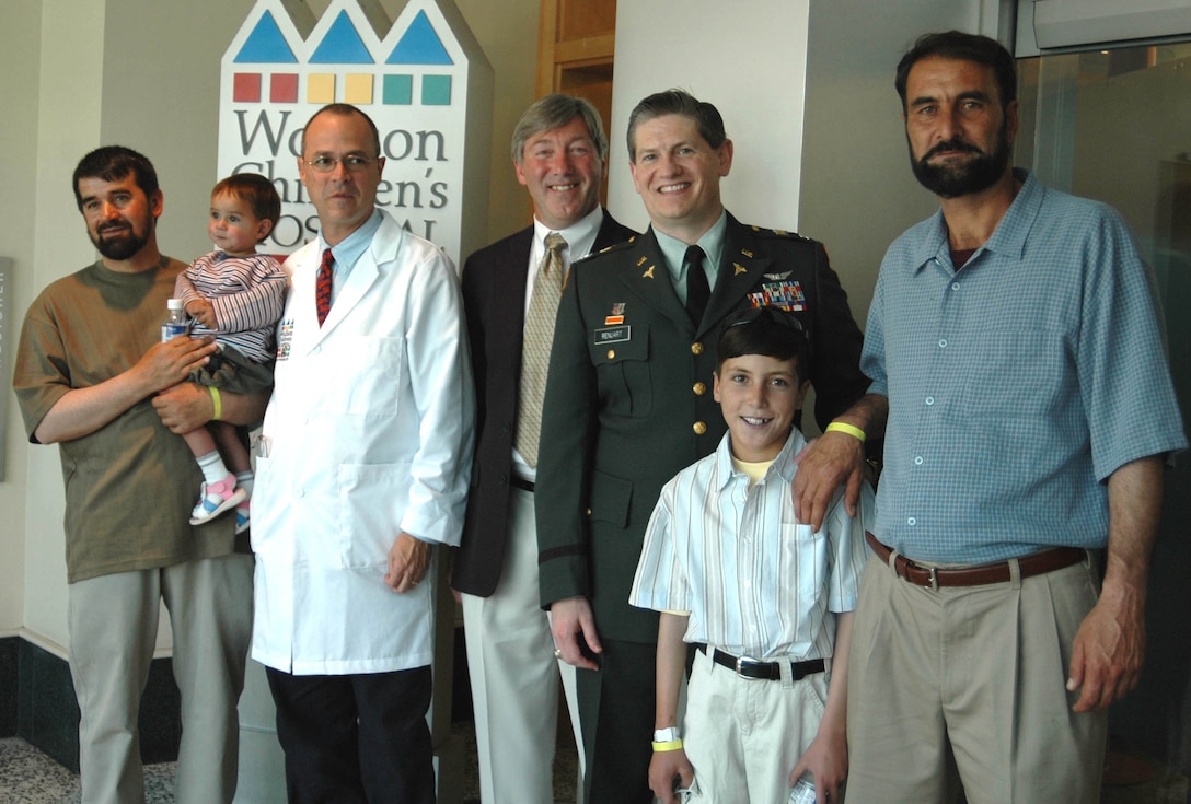 Dr. (Col.) Ronald Renuart poses with hospital staff, 2-year-old Azad ...