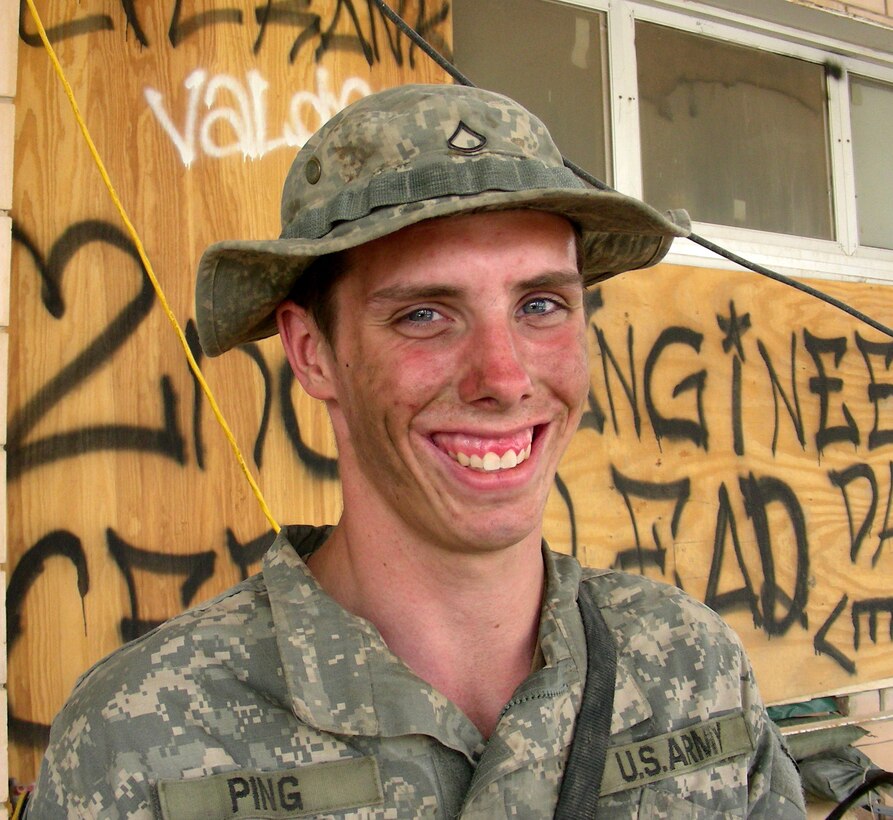 Army Pfc. Travis Ping smiles after finishing changing track pads on his ...
