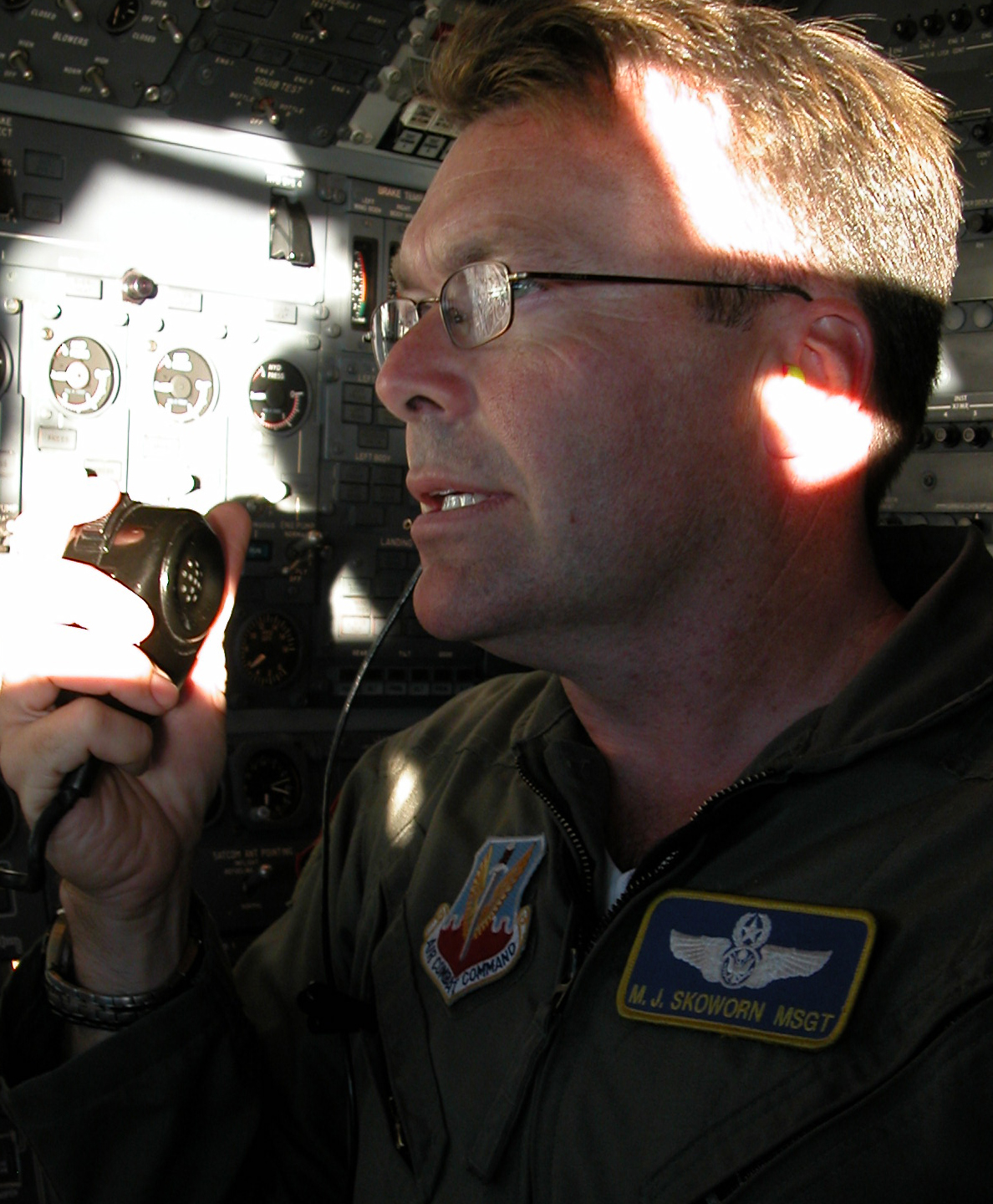 Air Force flight engineer Master Sgt. Mike Skoworn maintains radio ...