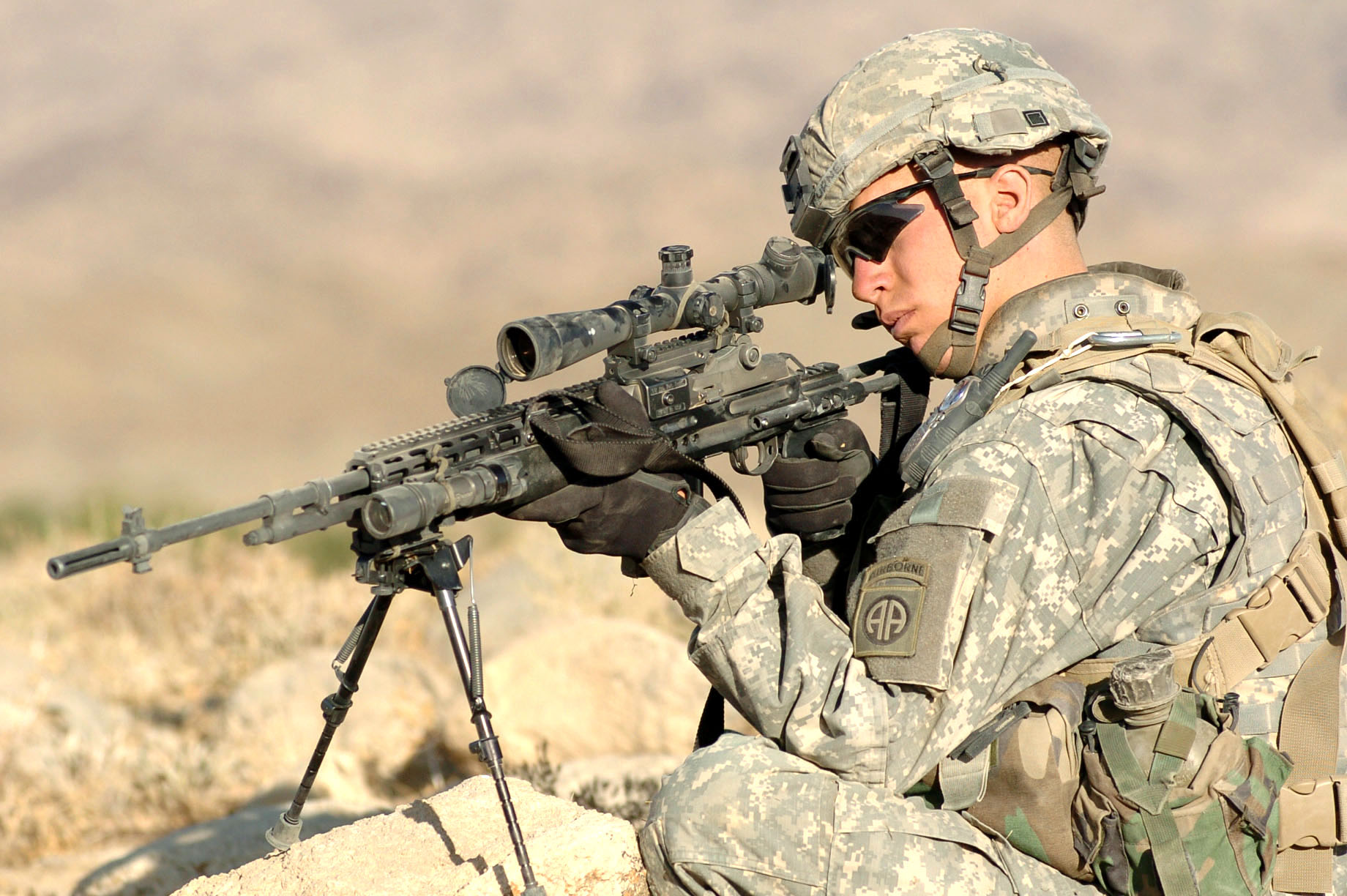 Army Spc. Ronald Turner provides "overwatch" protection from atop a ...