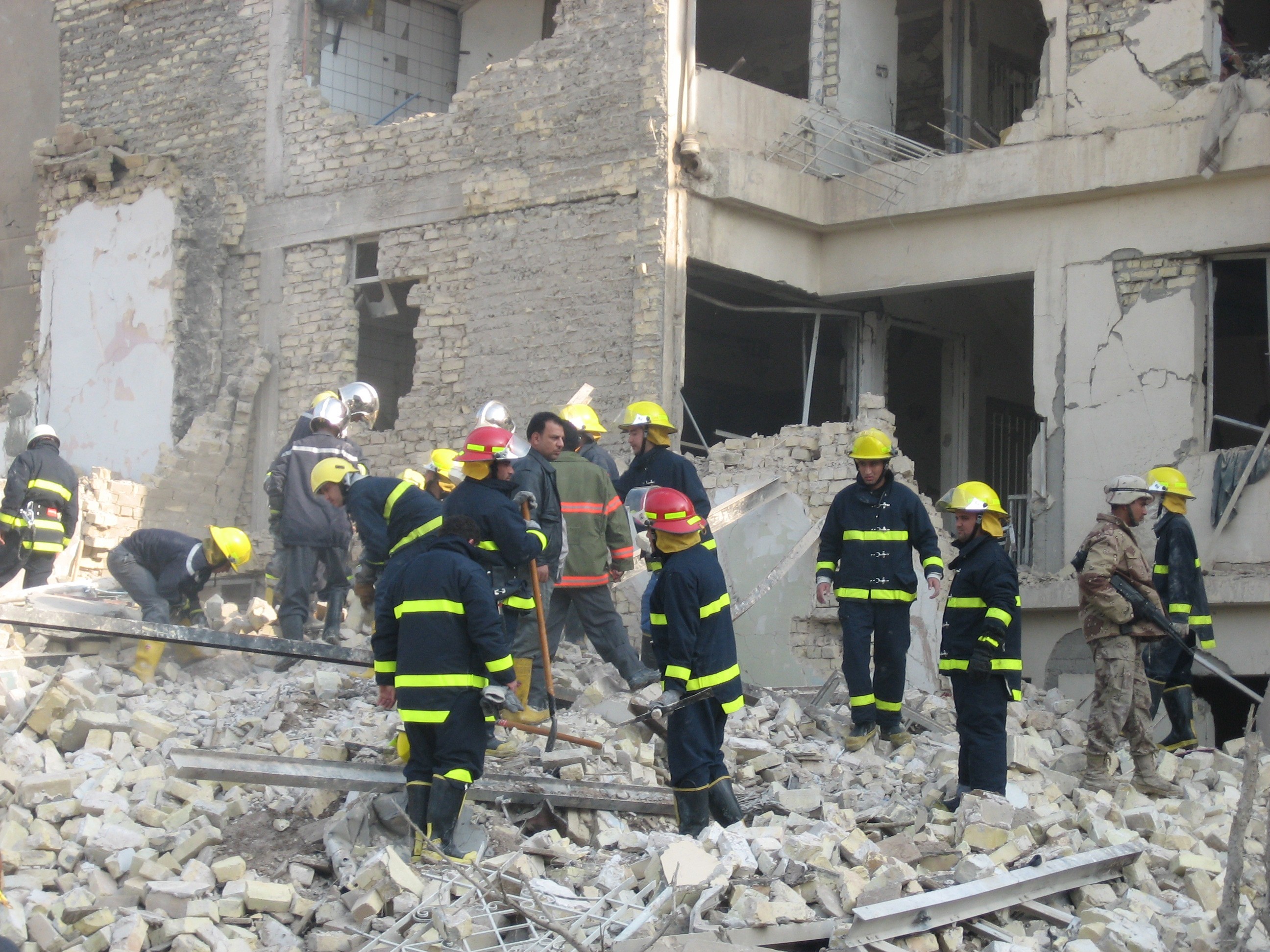 Iraqi firefighters work diligently to clear the rubble to rescue ...