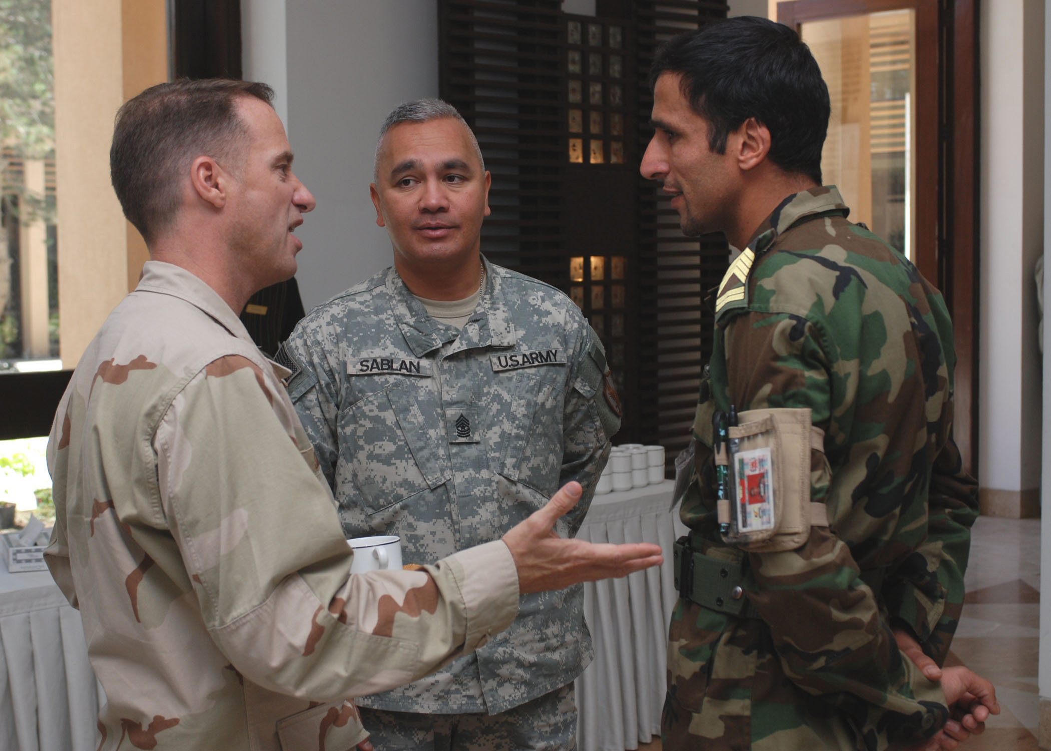 U.S. Navy Master Chief Petty Officer Kevin Smith talks with U.S. Army ...