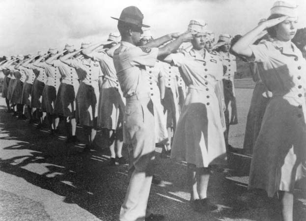 A Marine Corps drill sergeant shows recruits how to render a proper ...