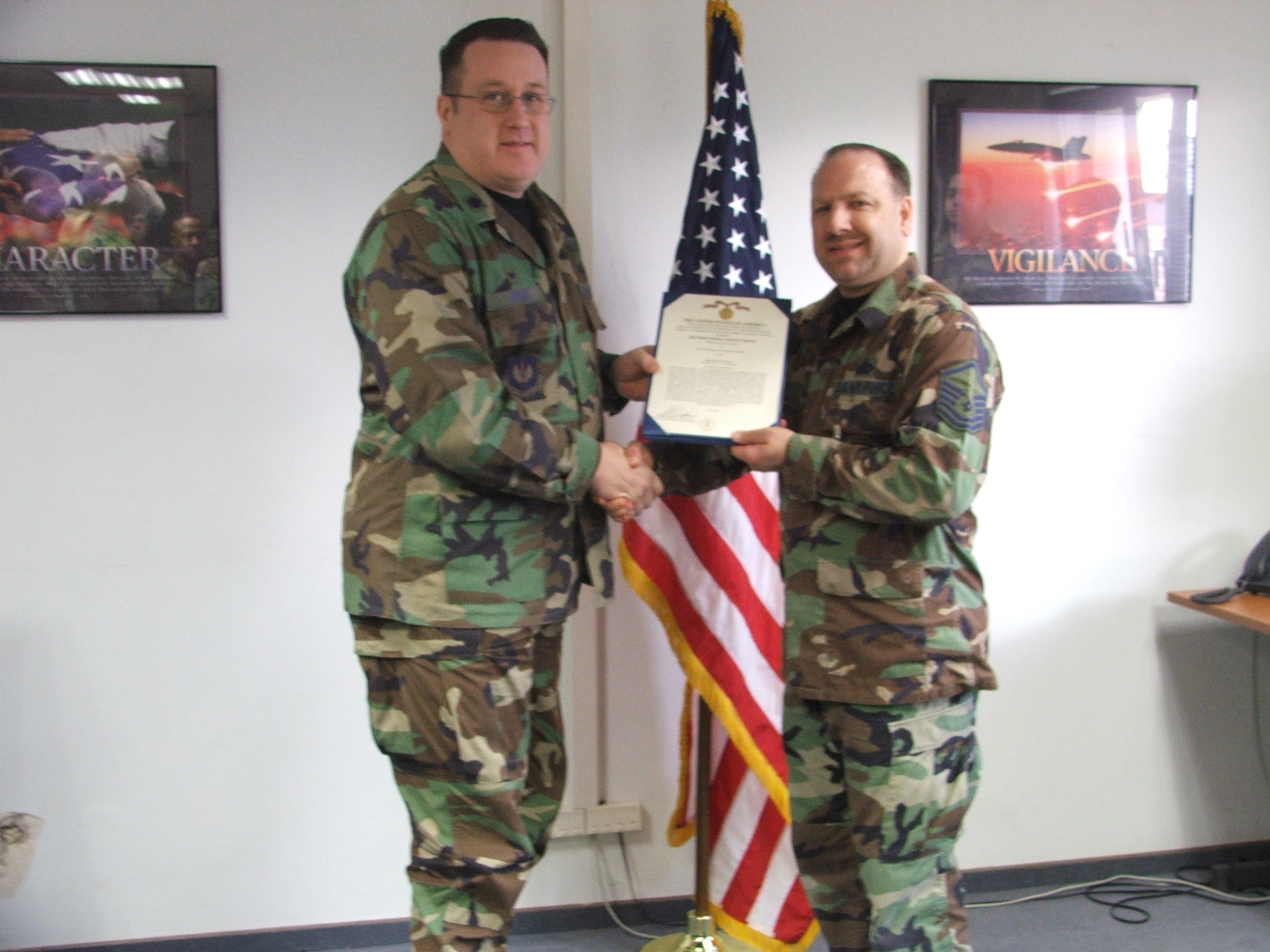Lt Col Price, USAFE/CSS, presents medals to unit members