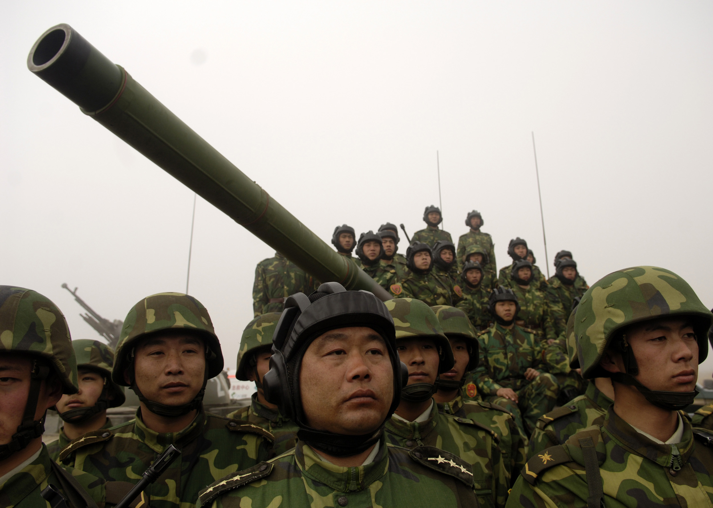 Chinese tanker soldiers with the People's Liberation Army listen as the ...