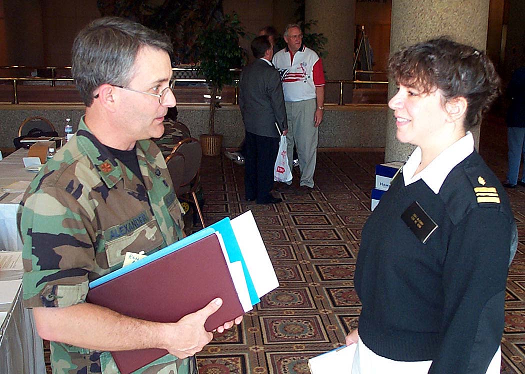 Air Force Maj. Ronald W. Alexander speaks with Dr. (Lt. Cmdr.) Lisa J ...