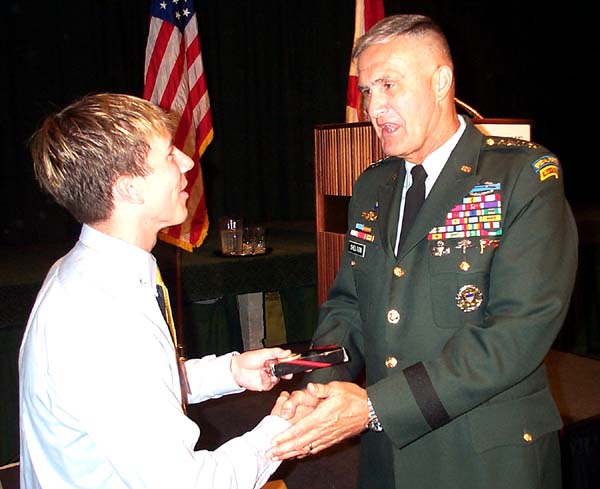 Former DoD Dependent Schools student Eric Mize is congratulated for a ...