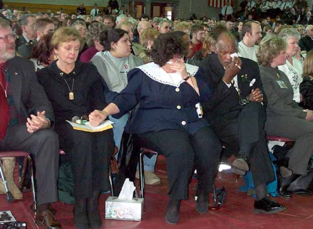 Family members weep and hold hands as an Army Reserve band plays "Some ...