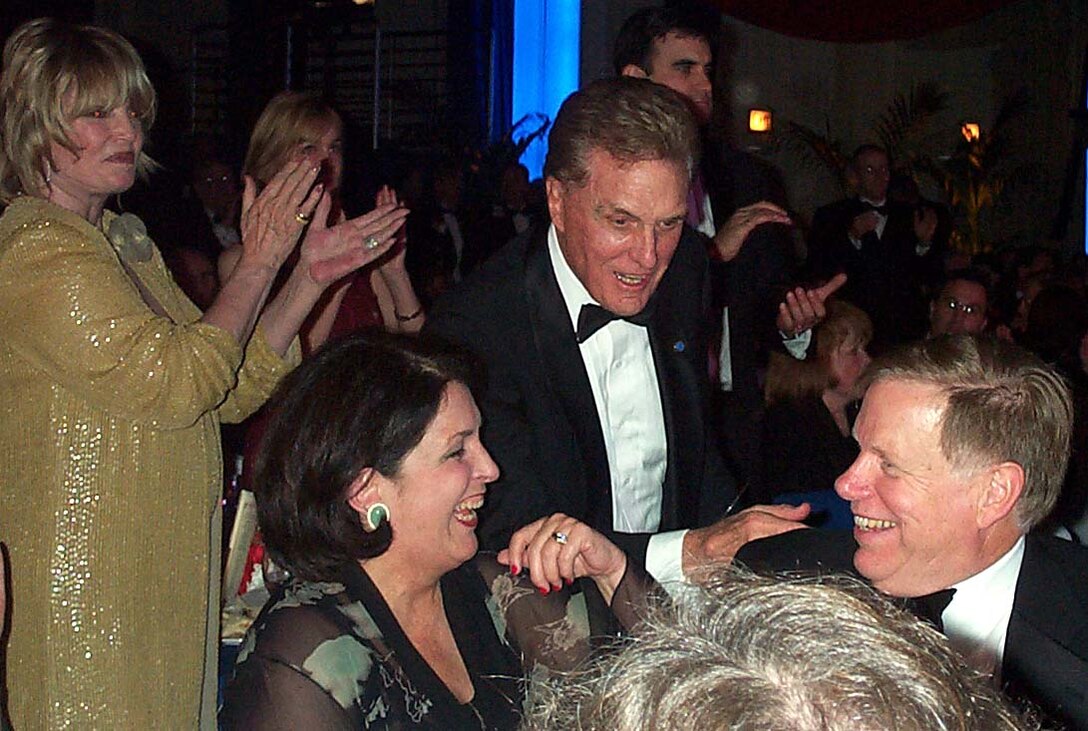 Rosemary Stack (standing left) and Robert Stack (center) greet fellow ...