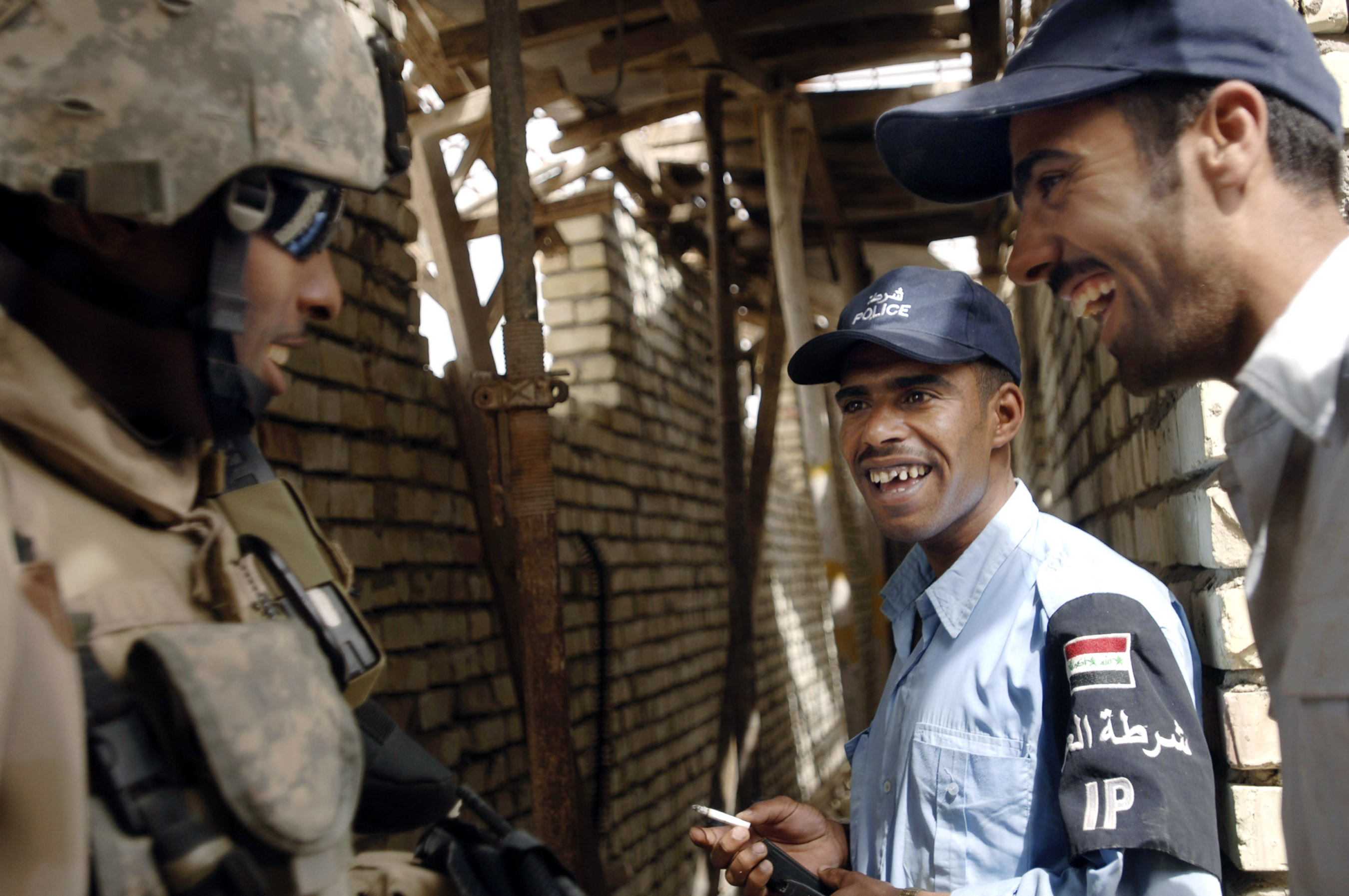 Staff Sgt. Michael Ellis laughs with Iraqi police, May 9, 2007, in a ...